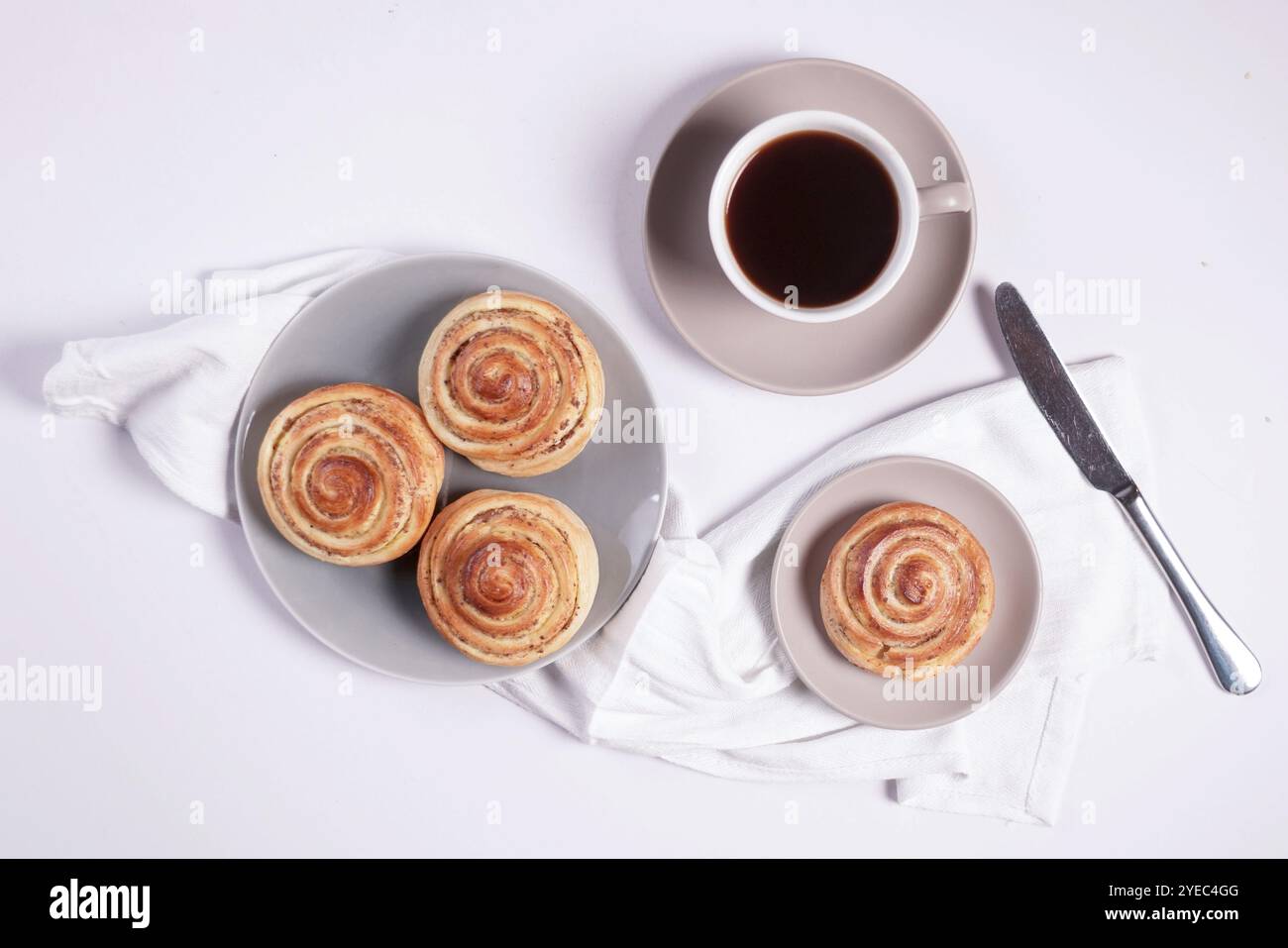 cinnamon roll with americano coffee cup top view in white background ...