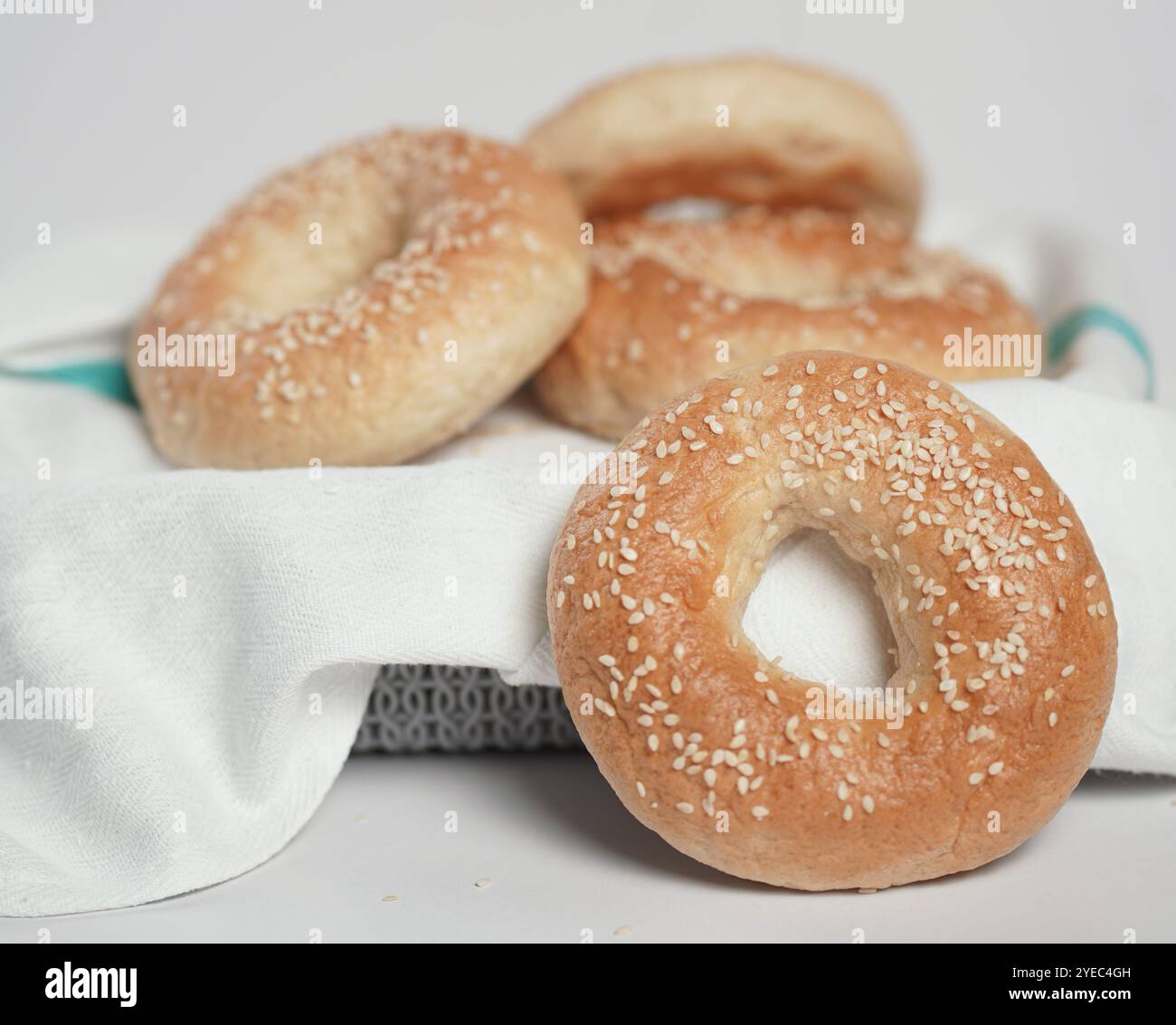 bagel with white sesame inside cloth basket in white background, High ...