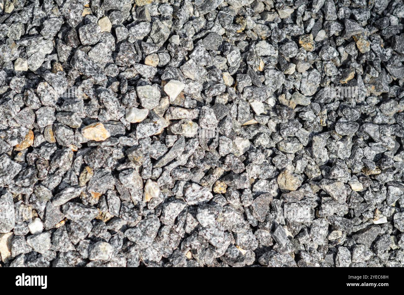 Abstract background of small stones. Gray crushed stone , scattered in ...