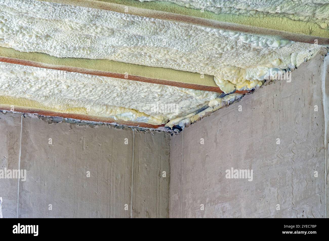 Internal construction work. Foam covers ceiling for insulation. Wooden ...