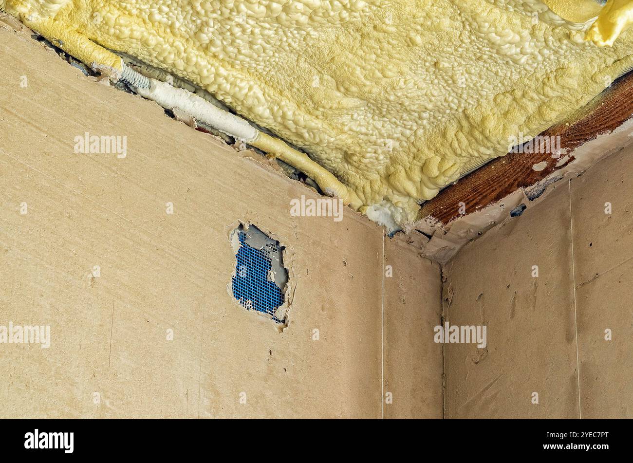 Internal construction work. Foam covers ceiling for insulation. Wooden ...