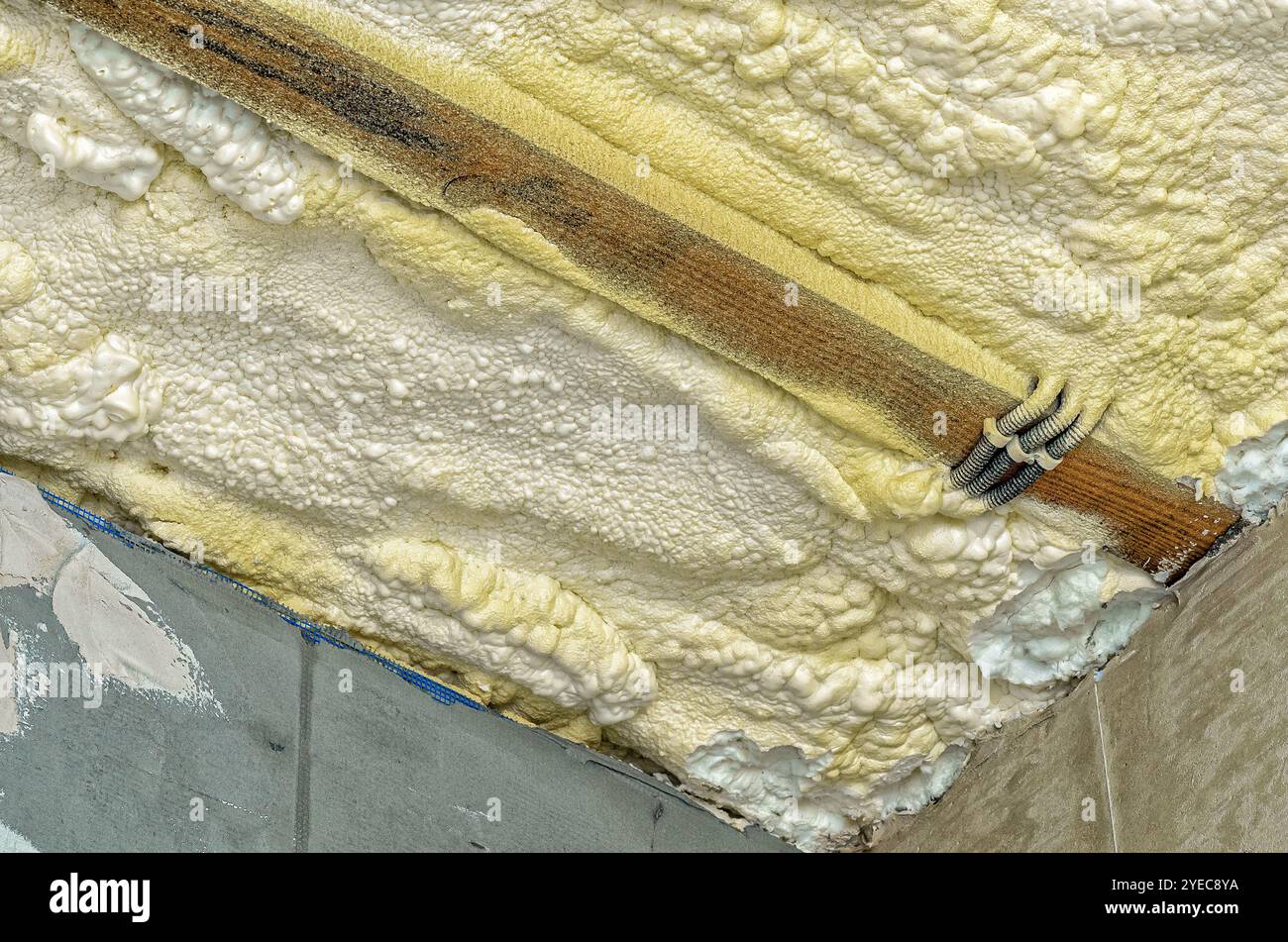 Foam covers ceiling for insulation. Internal construction work. Wooden ...