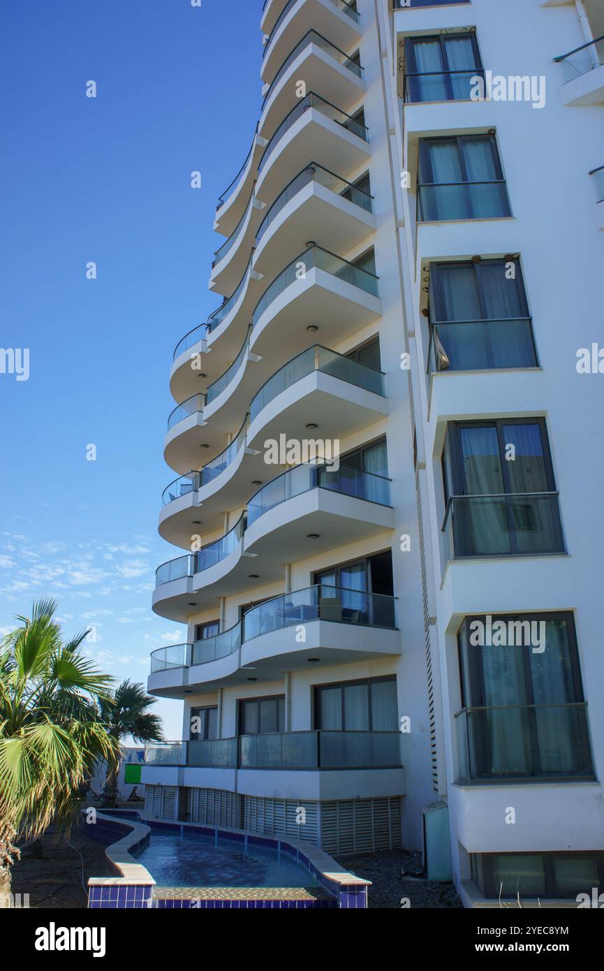 A stunning modern building features curved balconies against a backdrop ...
