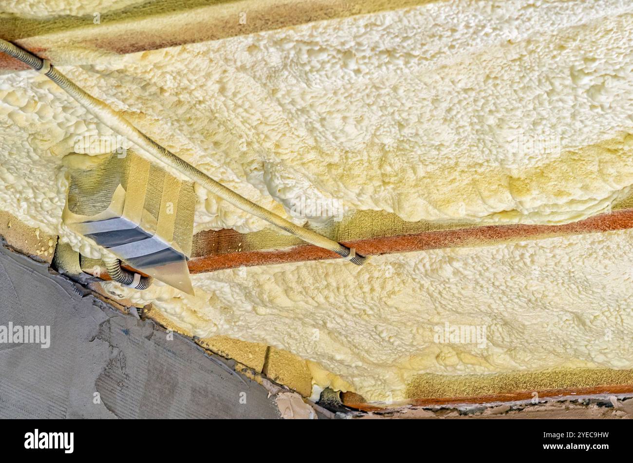 Foam insulation. View of ceiling of building with insulation pipes ...