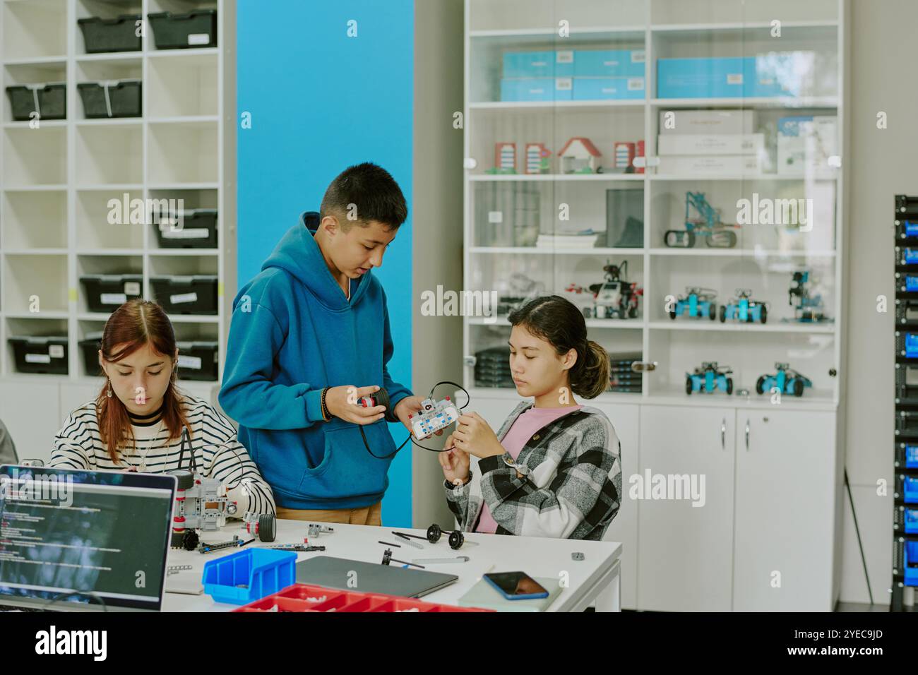 Boy and Girl texting together robot prototype while their classmate ...
