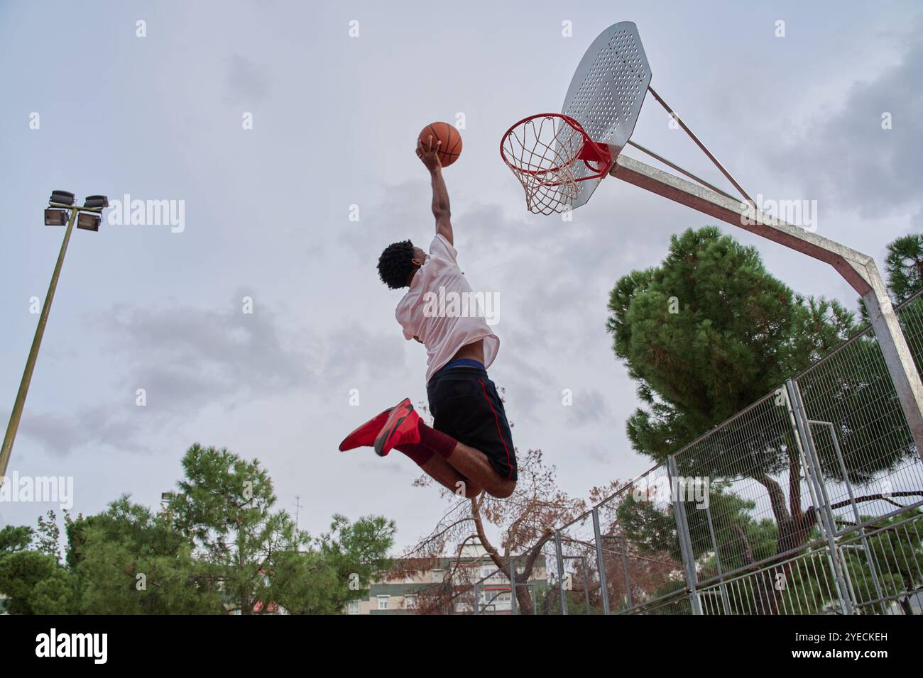 African-American male athlete playing basketball. young man dunking ...