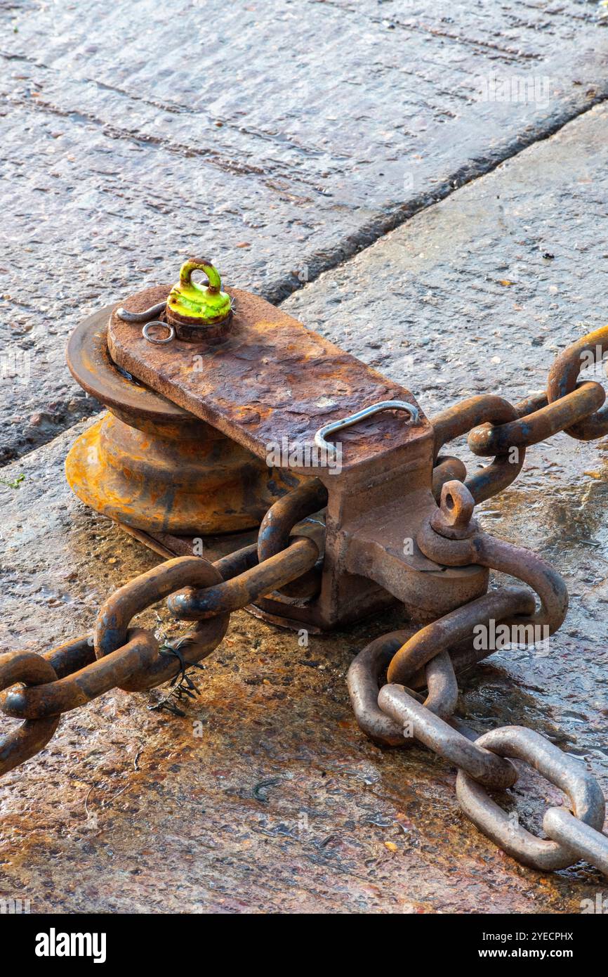 rusty and corroded old pulley block with wire cable and chain, ships ...