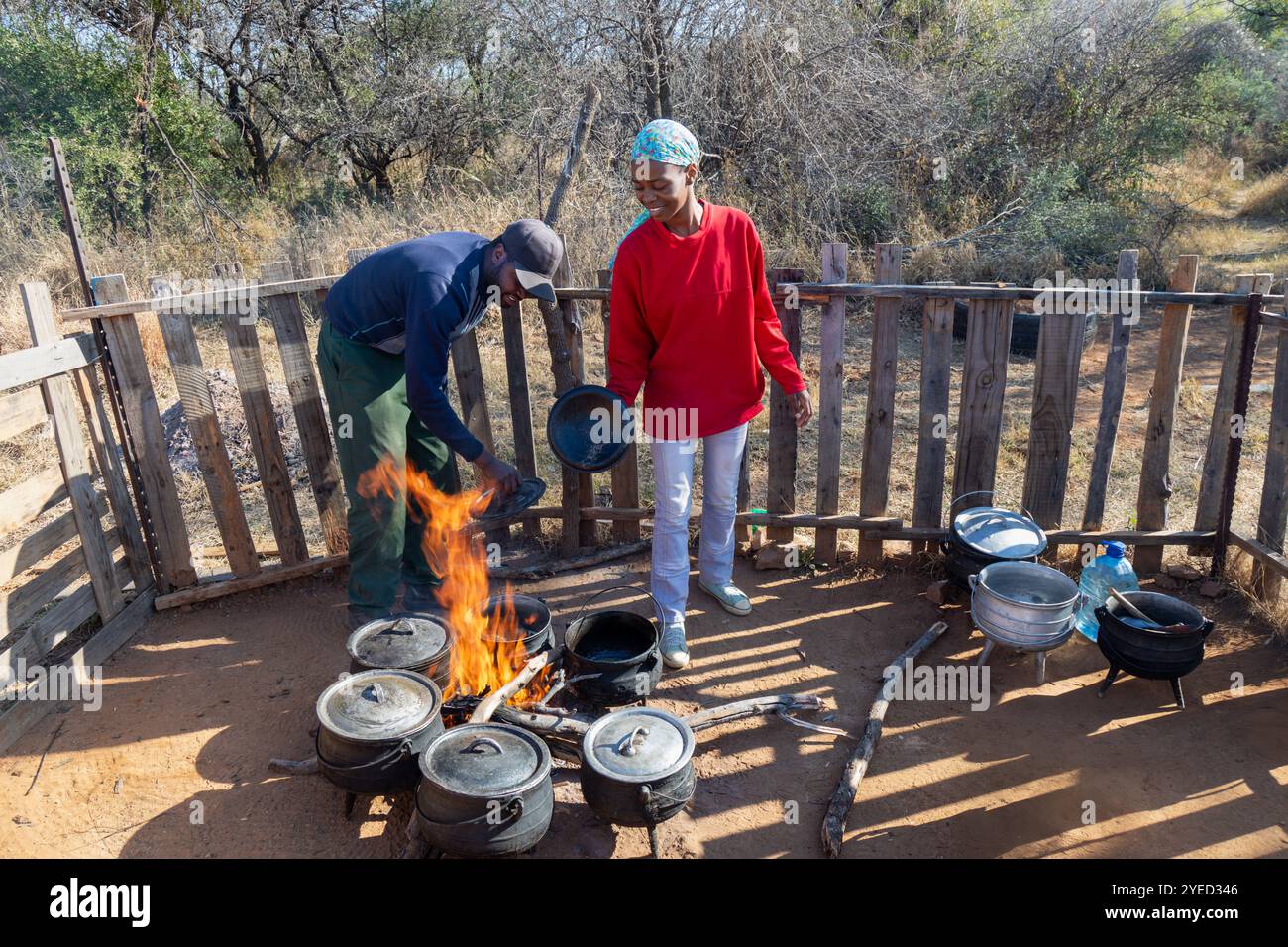 cooking in cauldron three legged pot african outdoors kitchen , street ...