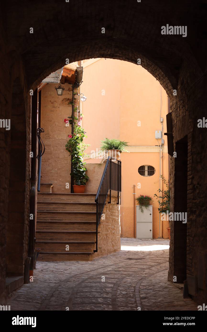 View through an archway along a narrow back street in an old town Stock ...