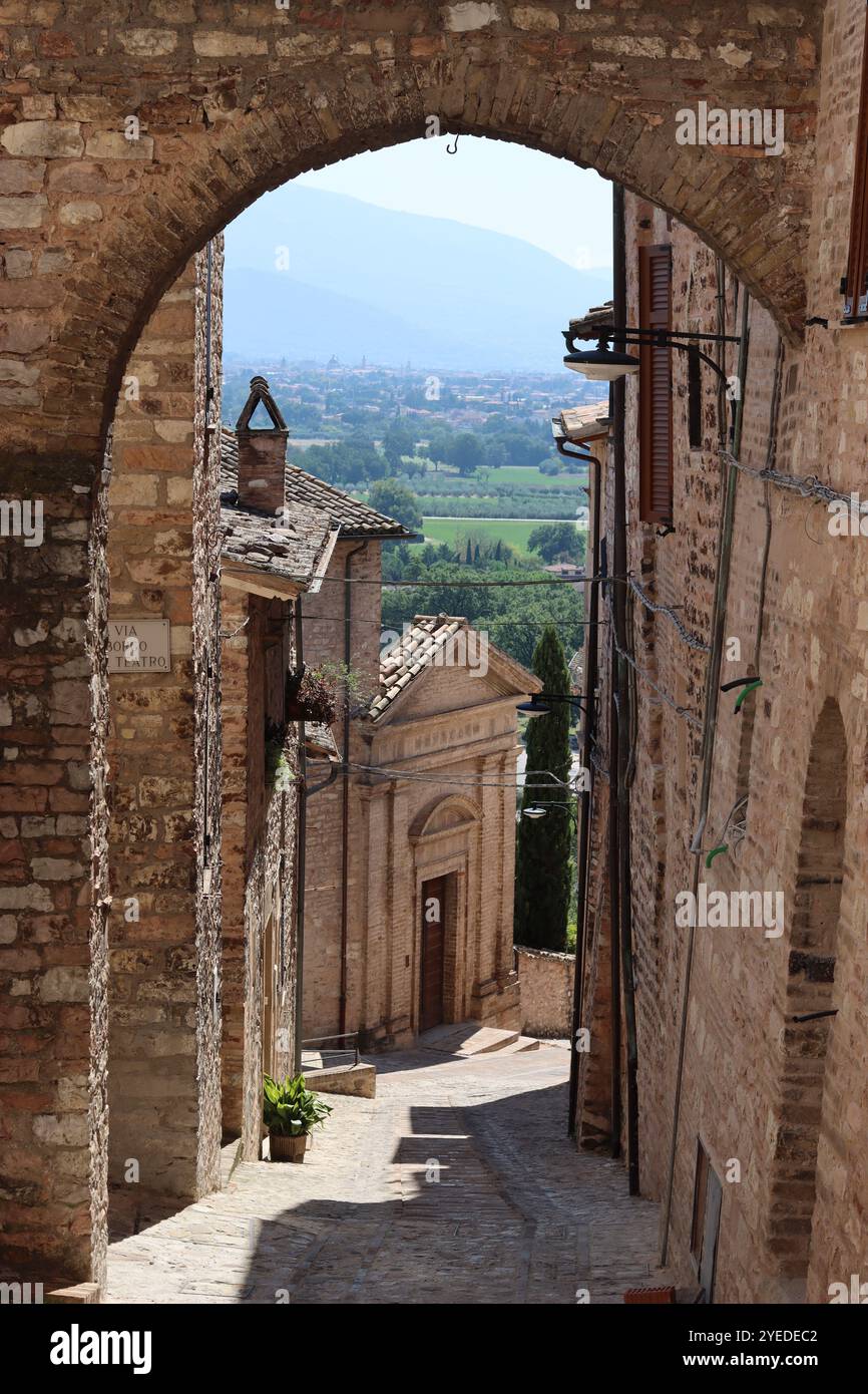 View through an archway along a narrow back street in an old town Stock ...