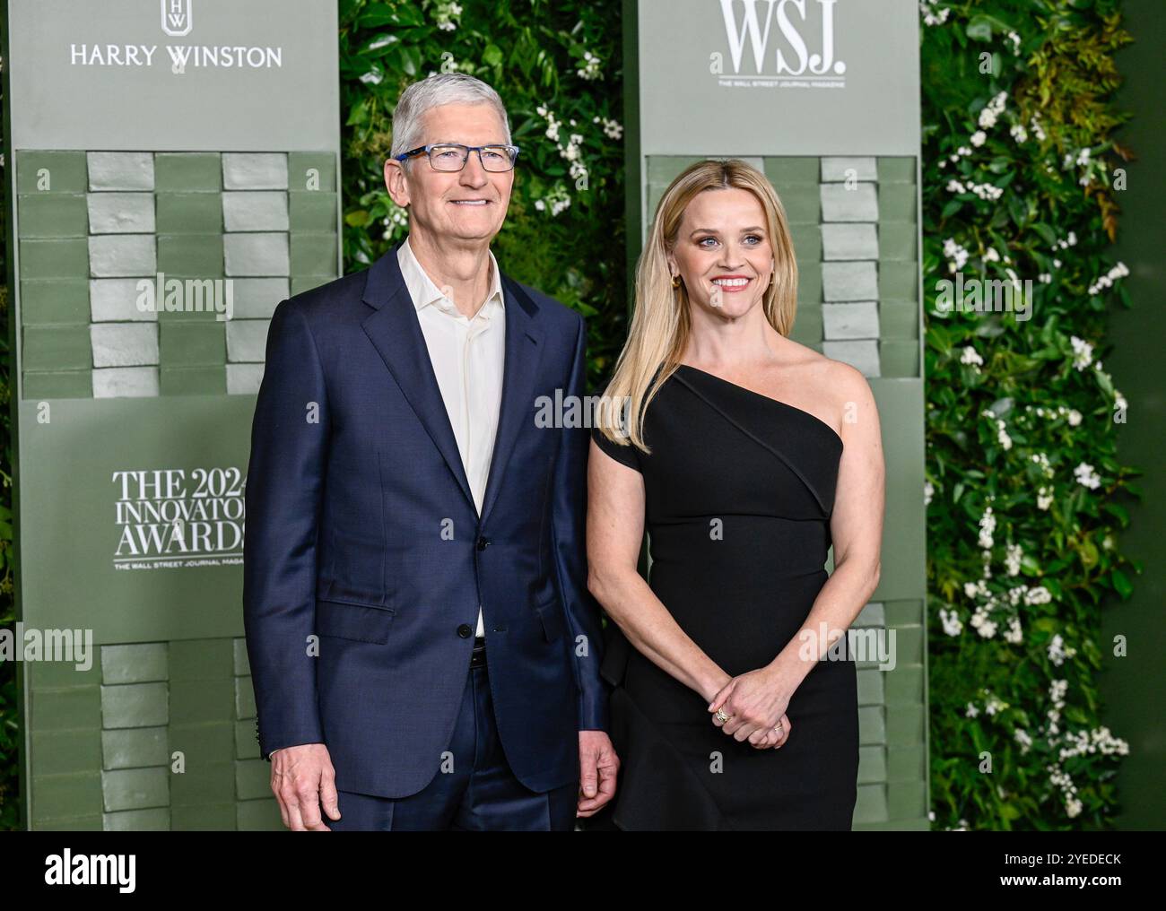 Tim Cook, left, and Reese Witherspoon attend the WSJ. Magazine ...