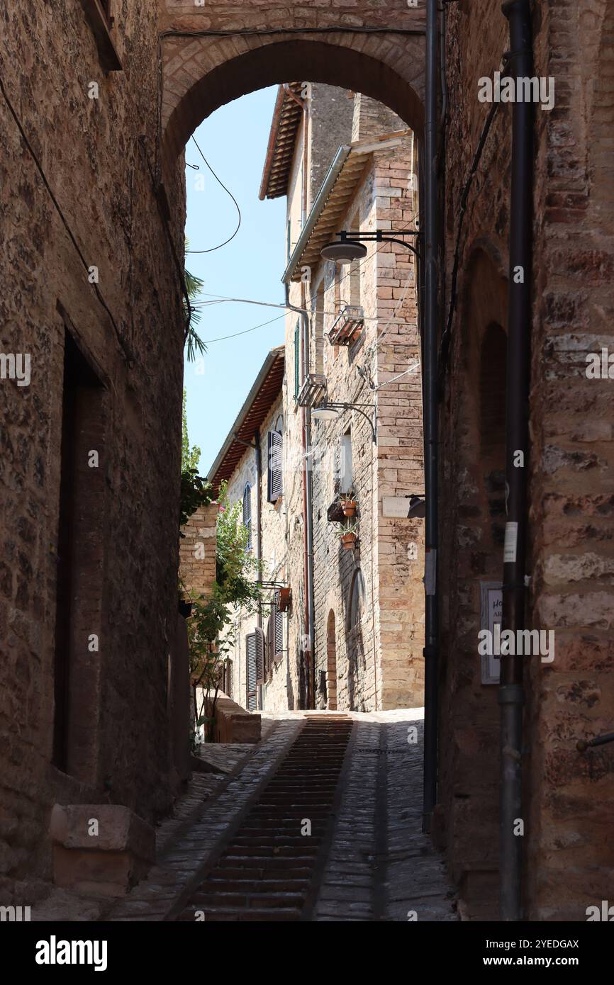 View through an archway along a narrow back street in an old town Stock ...