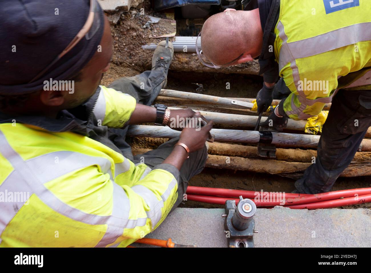 Workers working on utilities infrastructure electricity cables digging ...