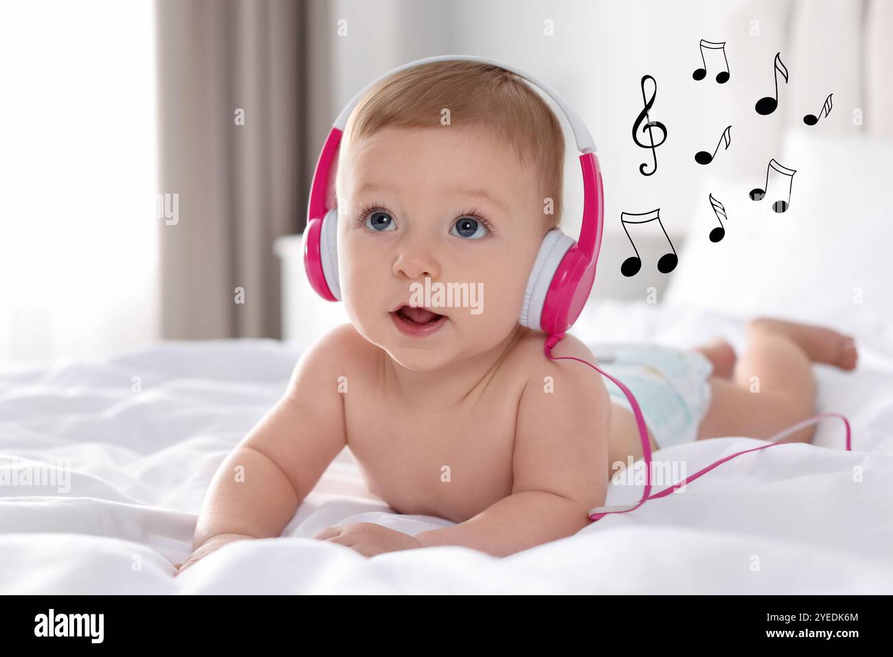 Cute little baby with headphones on bed at home. Music notes flying ...