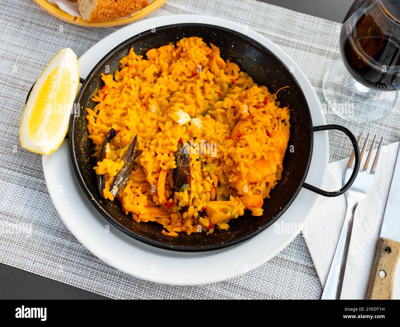 Spanish rice dish paella tinted with saffron. Prepared with olive oil ...