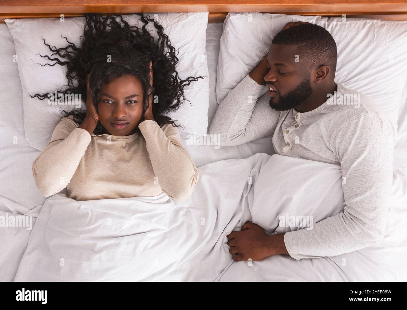 Black woman closing ears tired of her husband's noisy snoring Stock ...