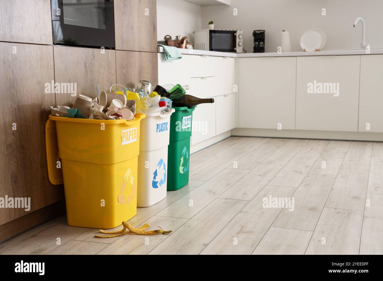 Full trash bins with different types of garbage in kitchen. Recycling ...