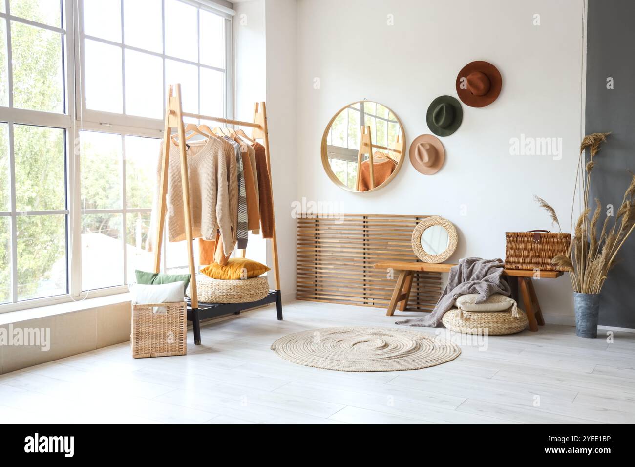 Interior of dressing room with wooden bench, clothes rack and mirrors ...