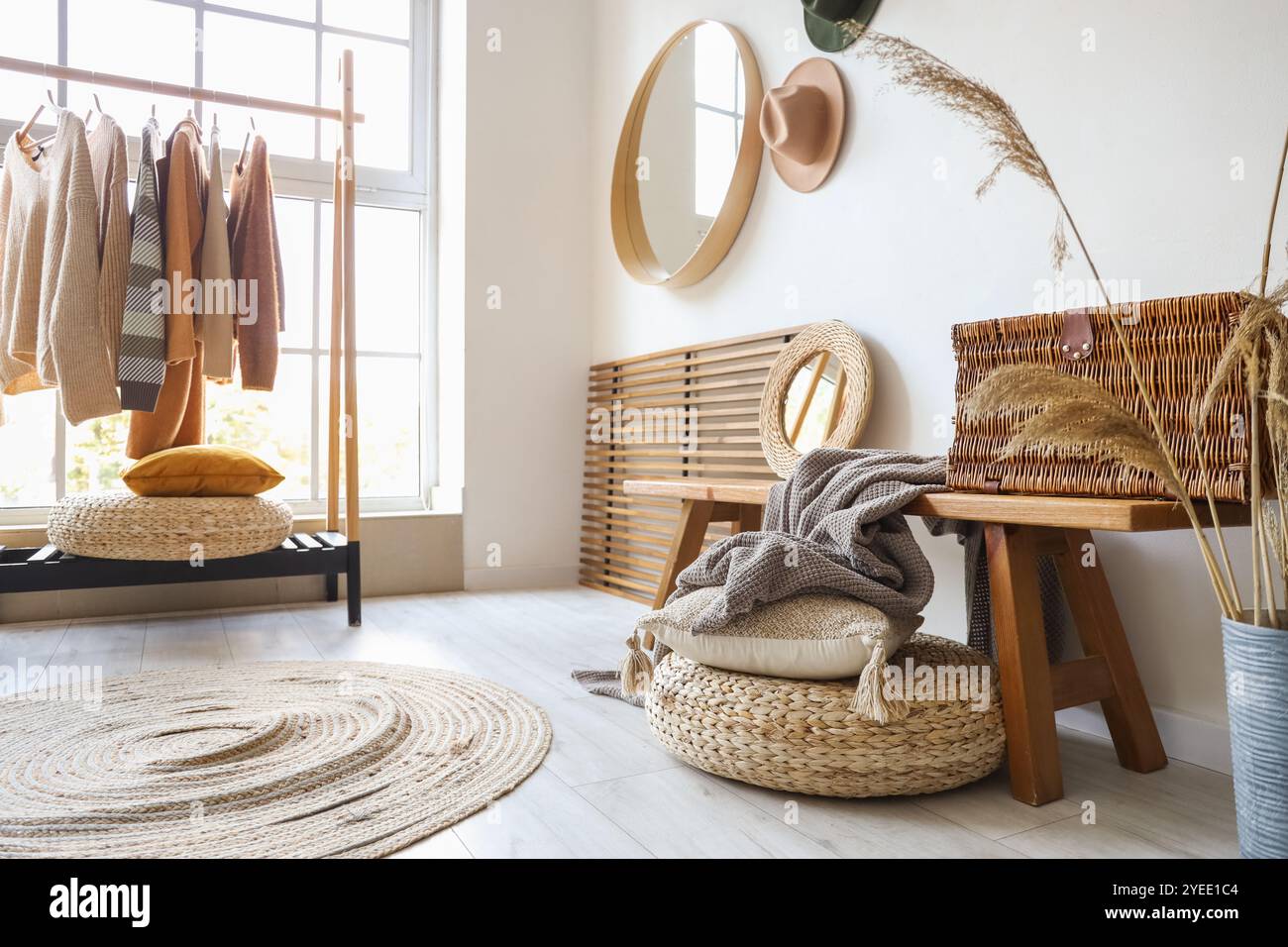 Interior of dressing room with wooden bench, clothes rack and mirrors ...