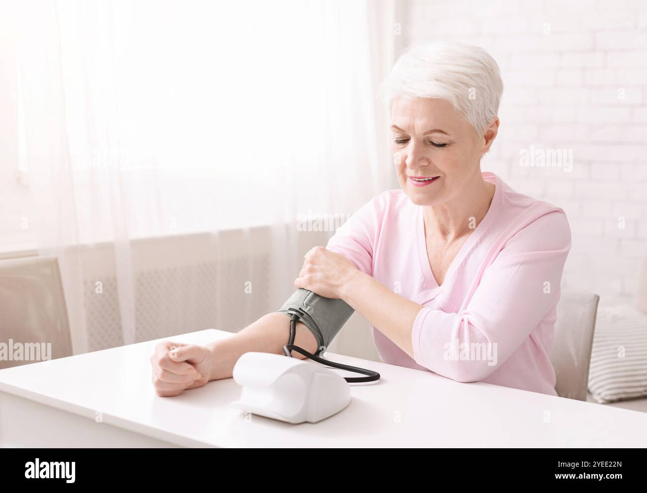 Senior lady with hypertension measuring blood pressure herself Stock ...