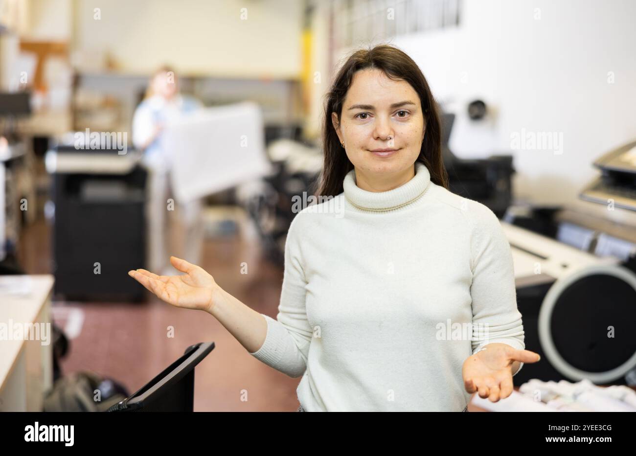 Friendly print shop employee invites customer to come inside Stock ...