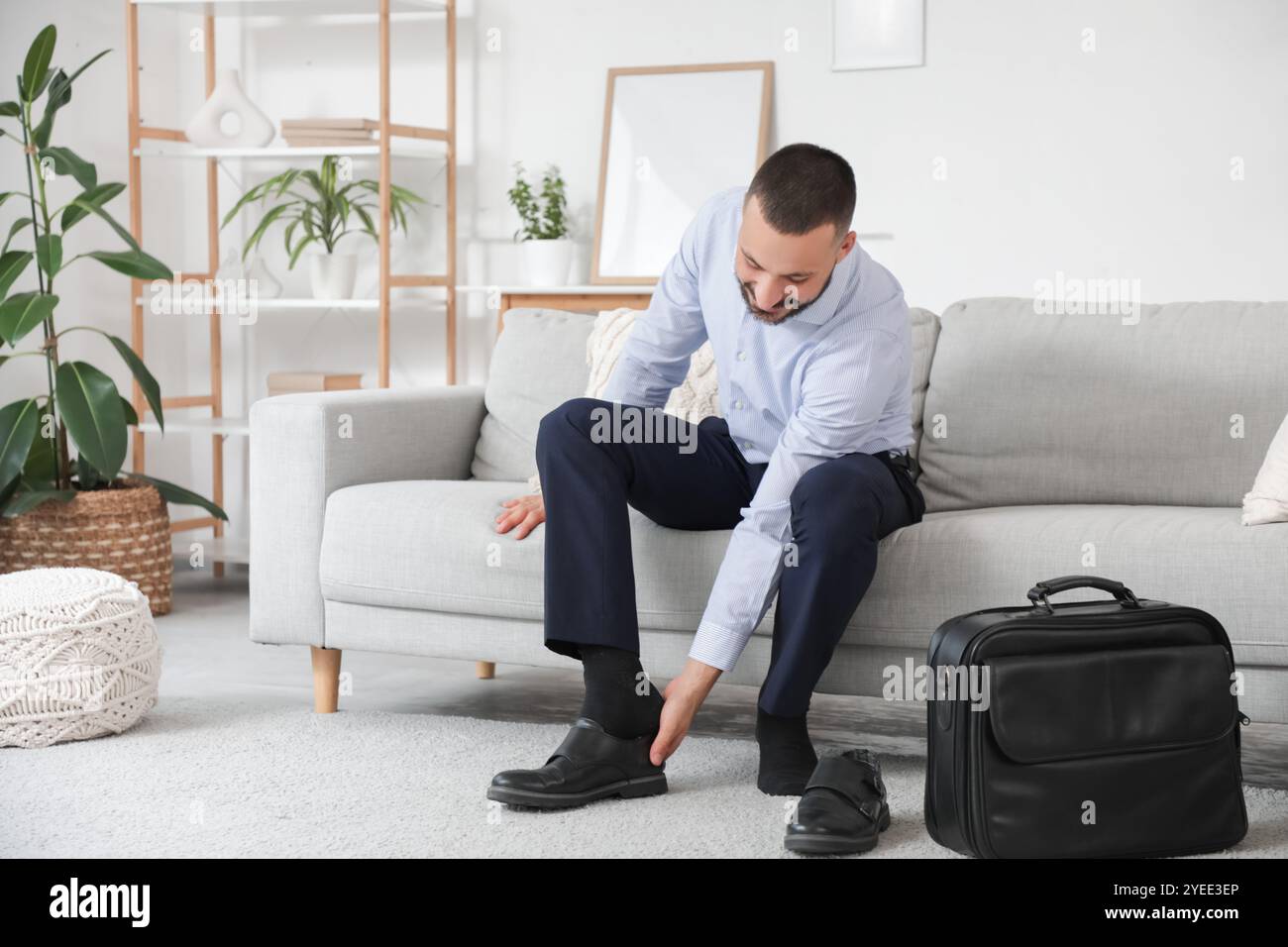 Man taking off his shoes hi-res stock photography and images - Alamy