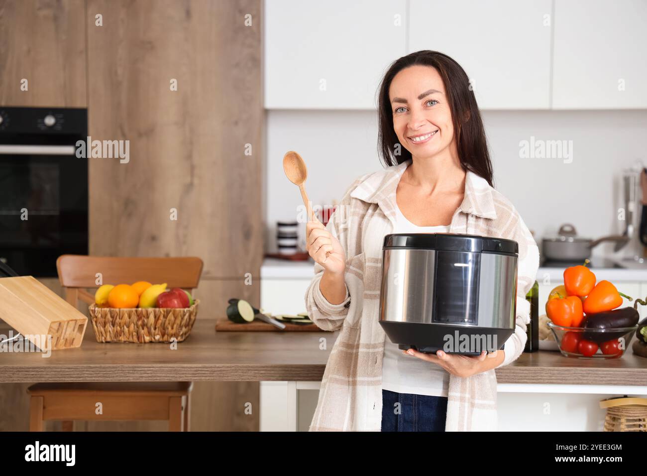 Beautiful woman multi cooker hi-res stock photography and images - Alamy