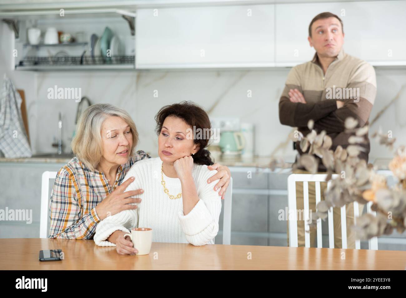Family quarrel, old woman calming woman Stock Photo - Alamy