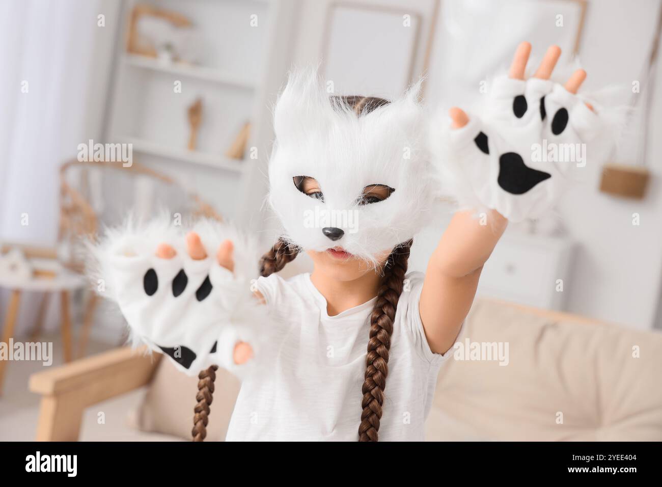Quadrober girl in cat mask at home Stock Photo - Alamy