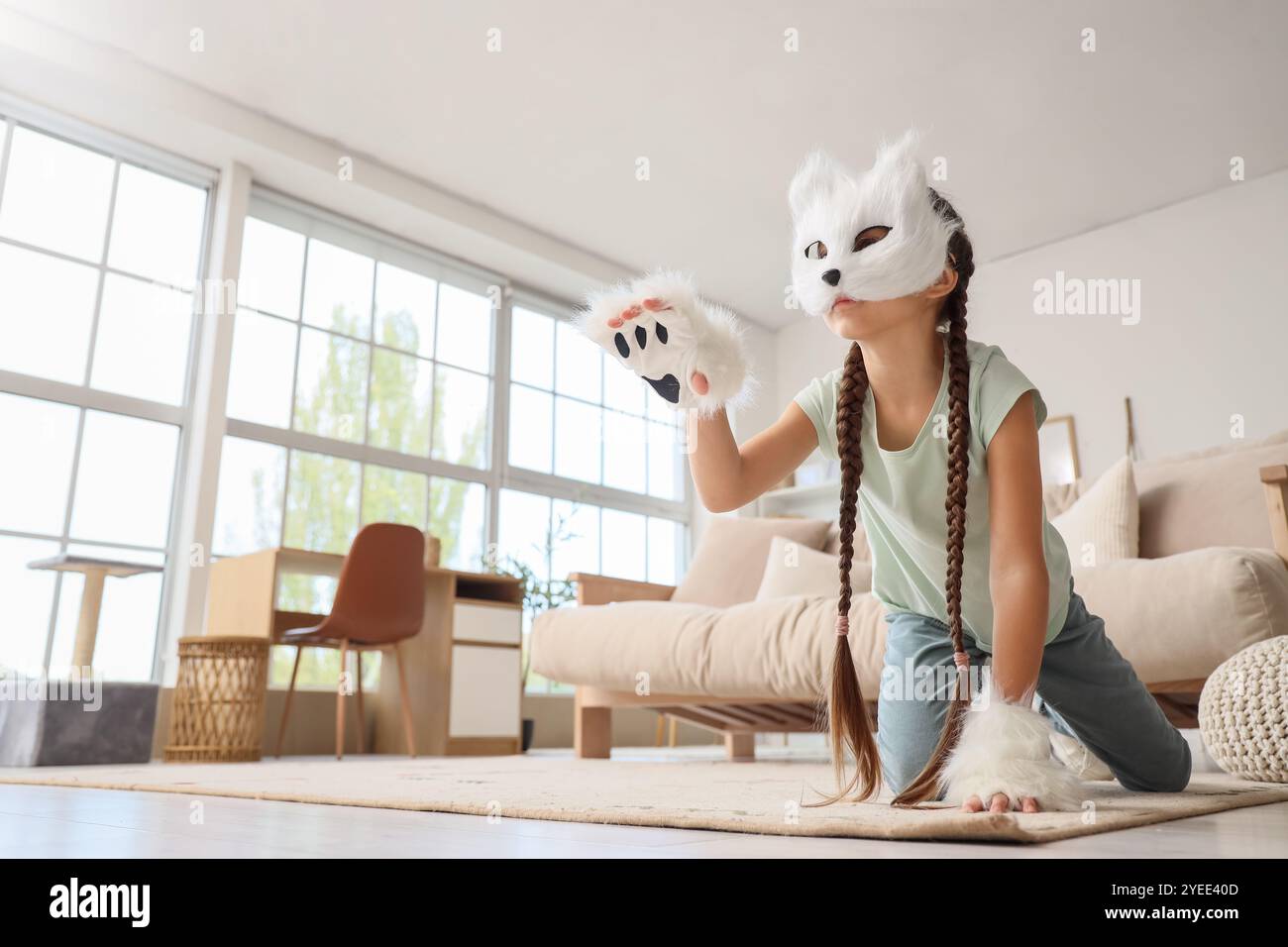 Quadrober girl in cat mask on carpet at home Stock Photo - Alamy