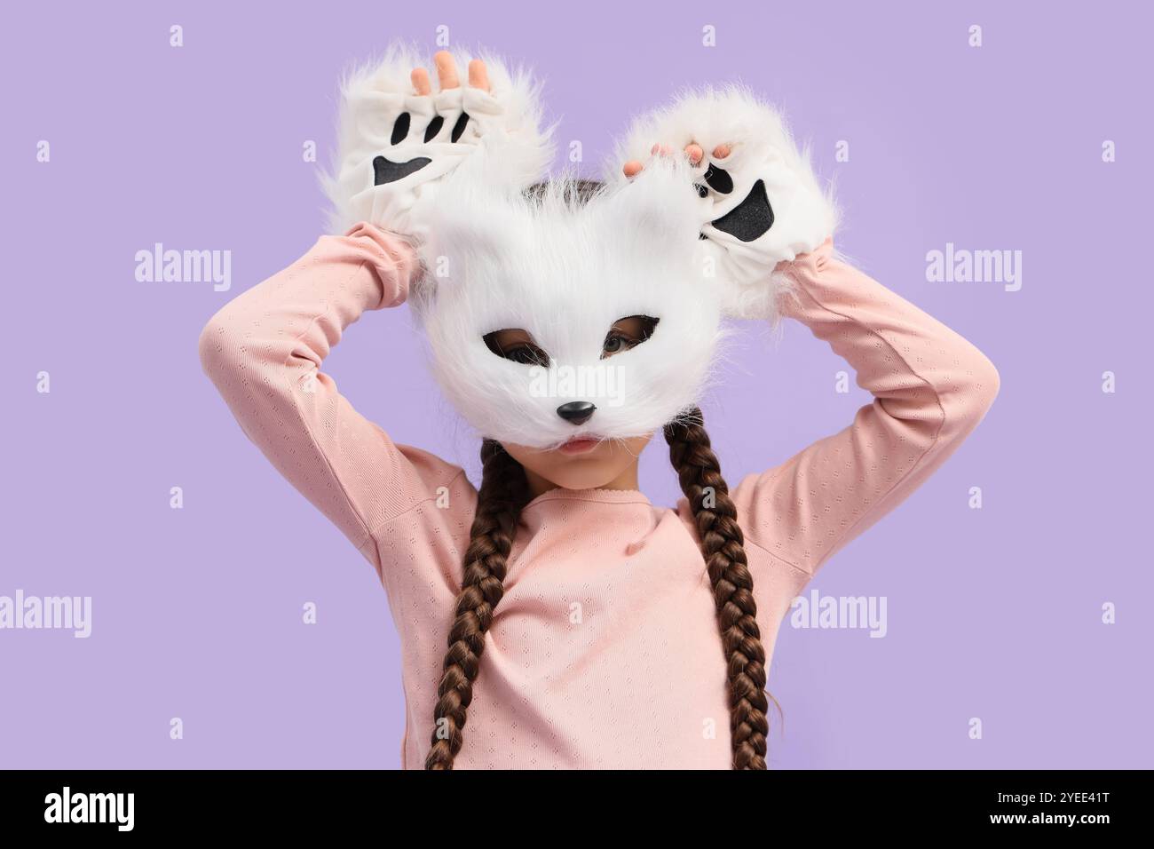 Quadrober girl in cat mask on lilac background Stock Photo - Alamy