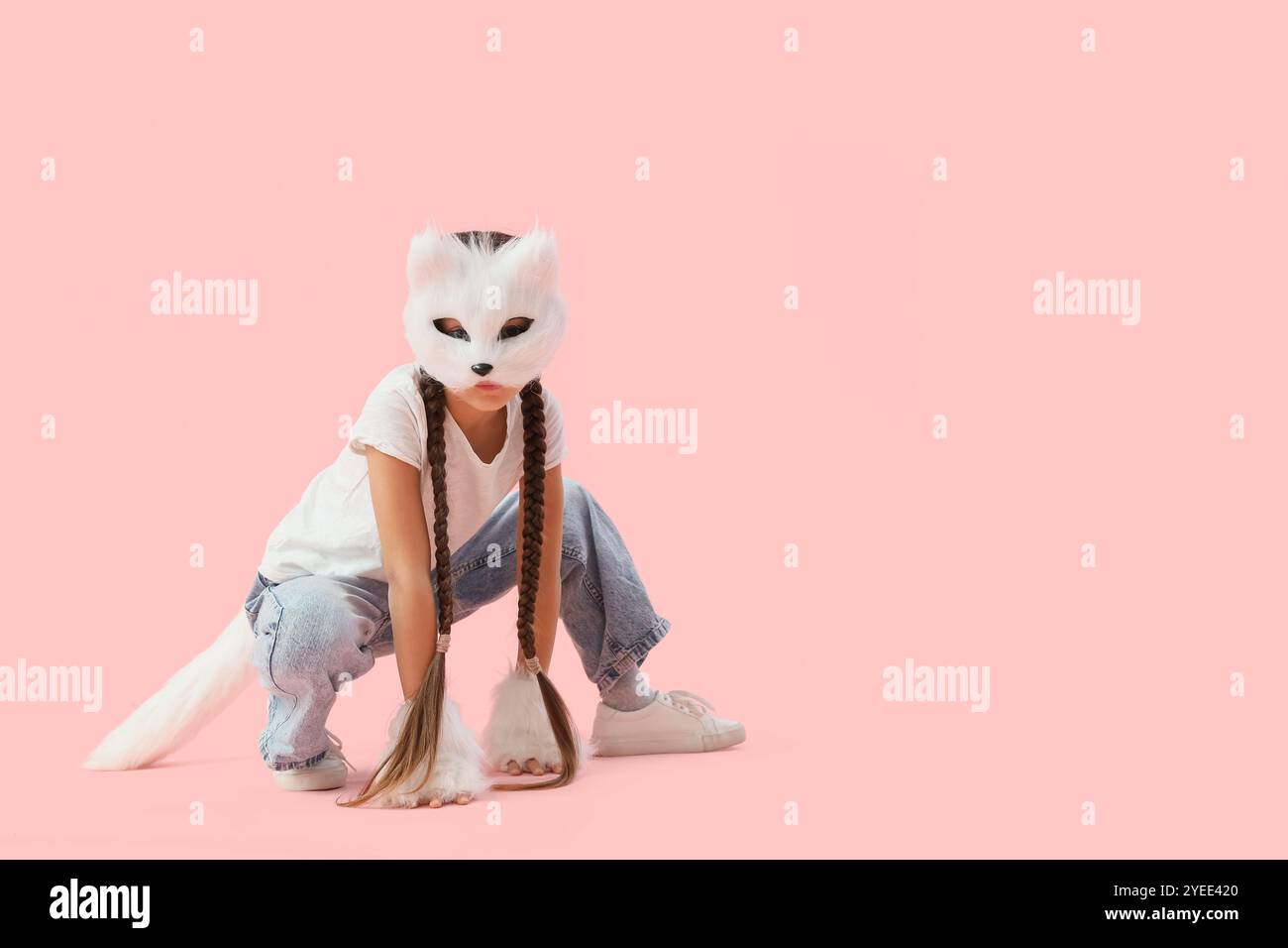 Quadrober girl in cat mask sitting on pink background Stock Photo - Alamy