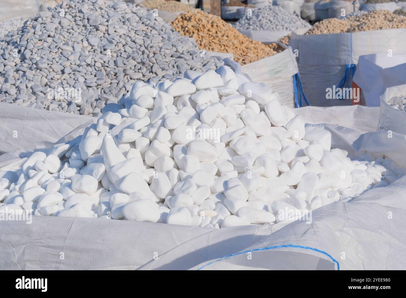 White marble pebbles are sold in construction market. Close up of ...