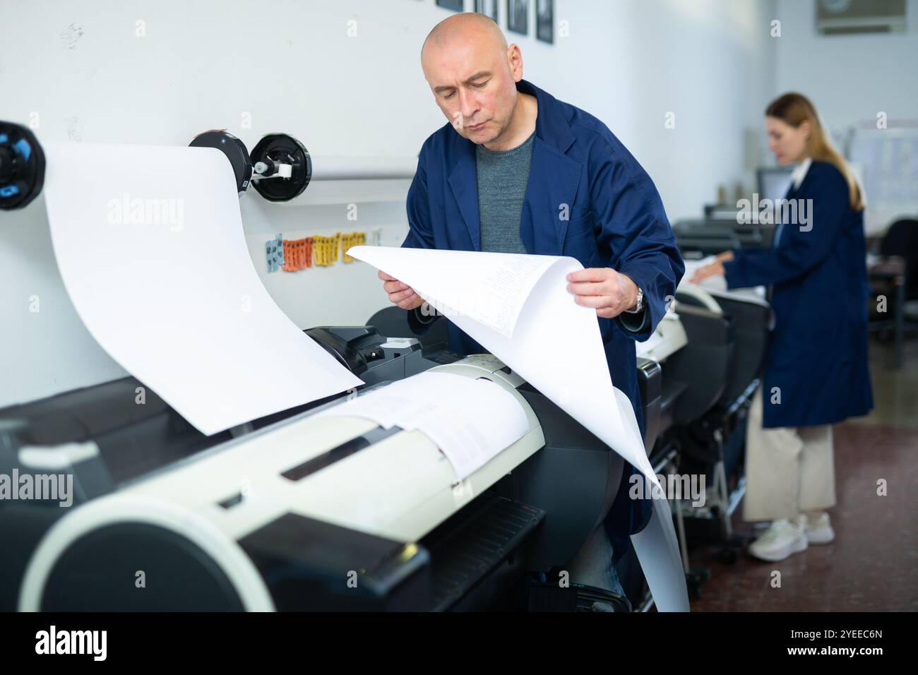 Man working in printing office, using printer Stock Photo - Alamy
