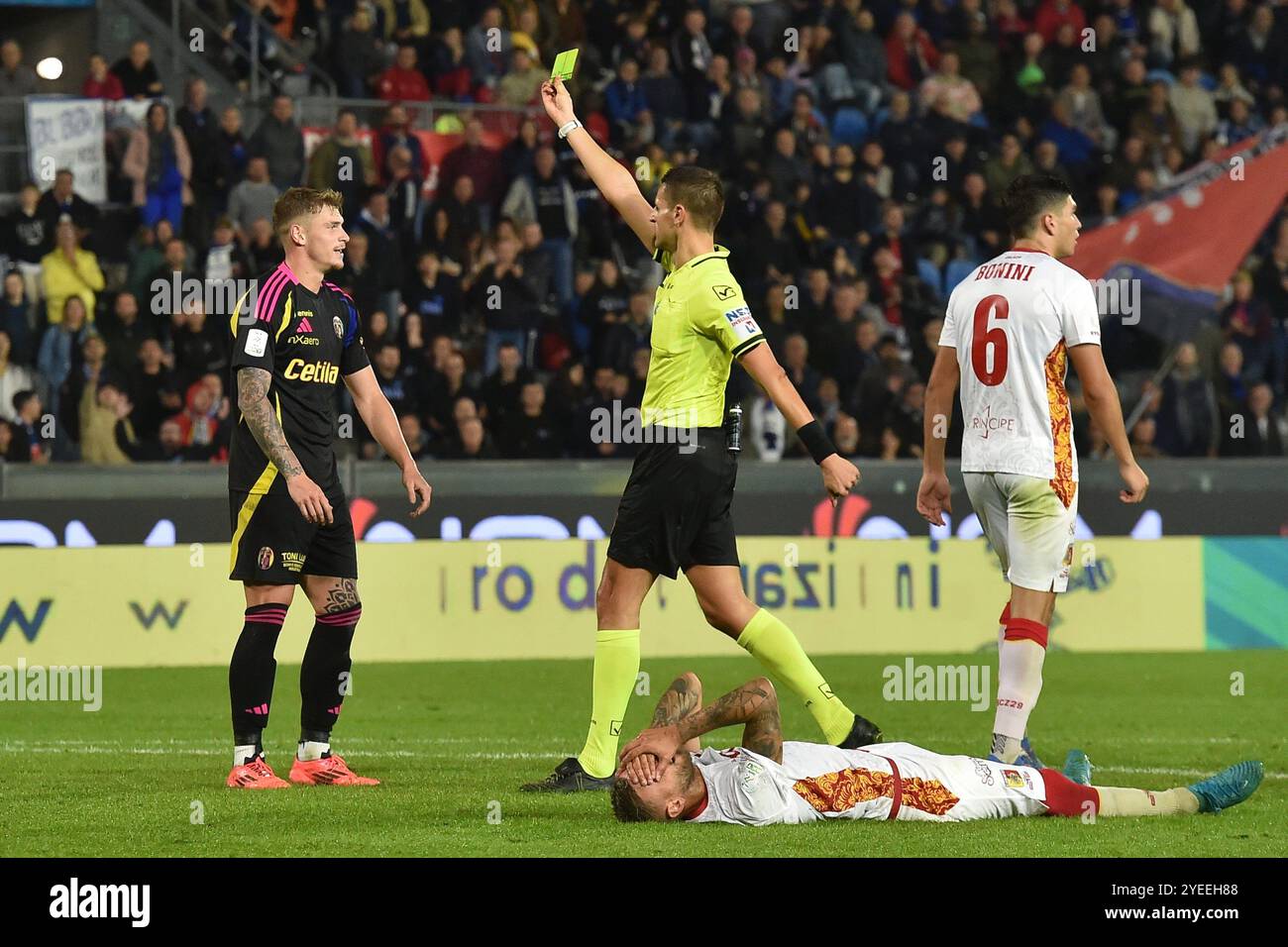 The referee Daniele Perenzoni shows yellow card to Nicholas Bonfanti ...
