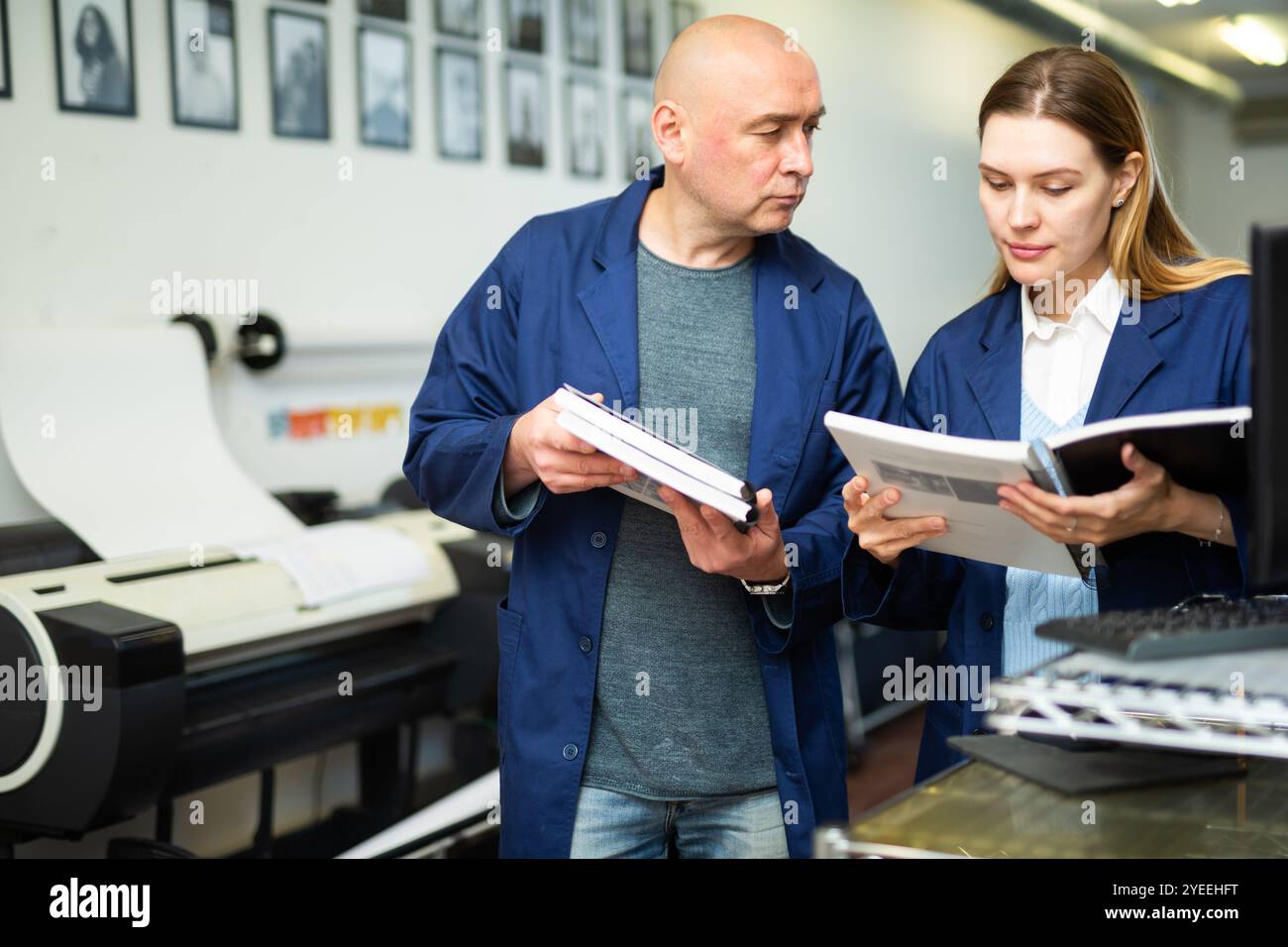Woman printing office worker reading operation manual Stock Photo - Alamy