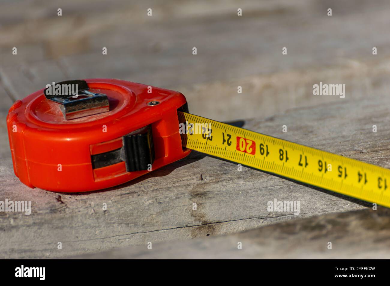 red and yellow construction tape measure, detail of a rolling meter or ...