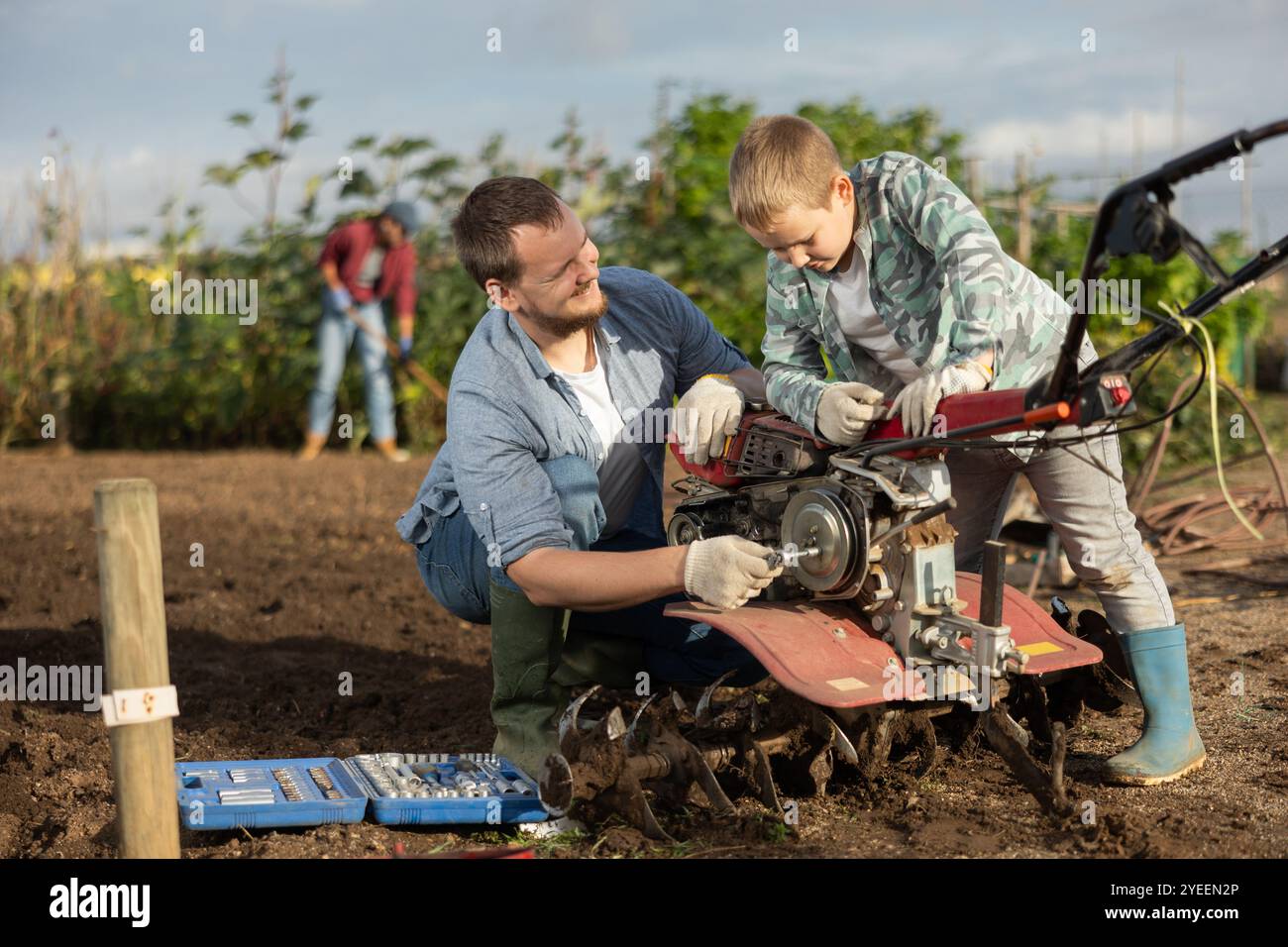 Man and his son are repairing garden equipment Stock Photo - Alamy