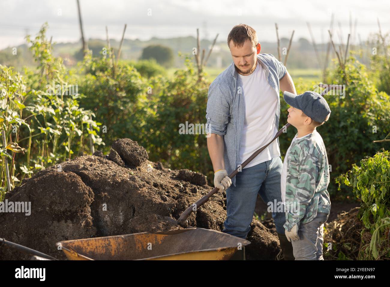 Man and son working with land on farm Stock Photo - Alamy