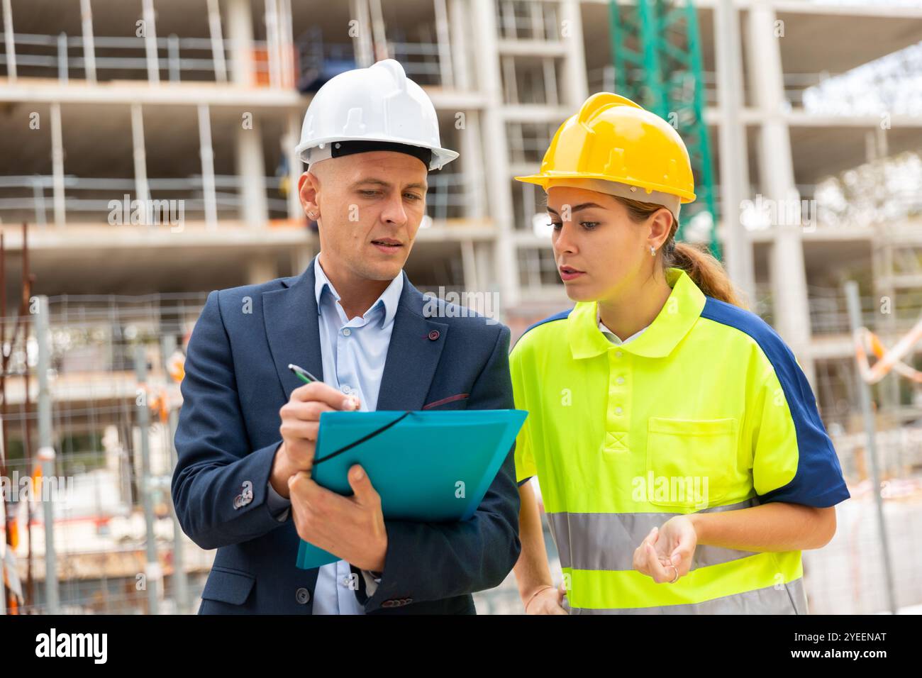 Man and woman engineers in construction site Stock Photo - Alamy