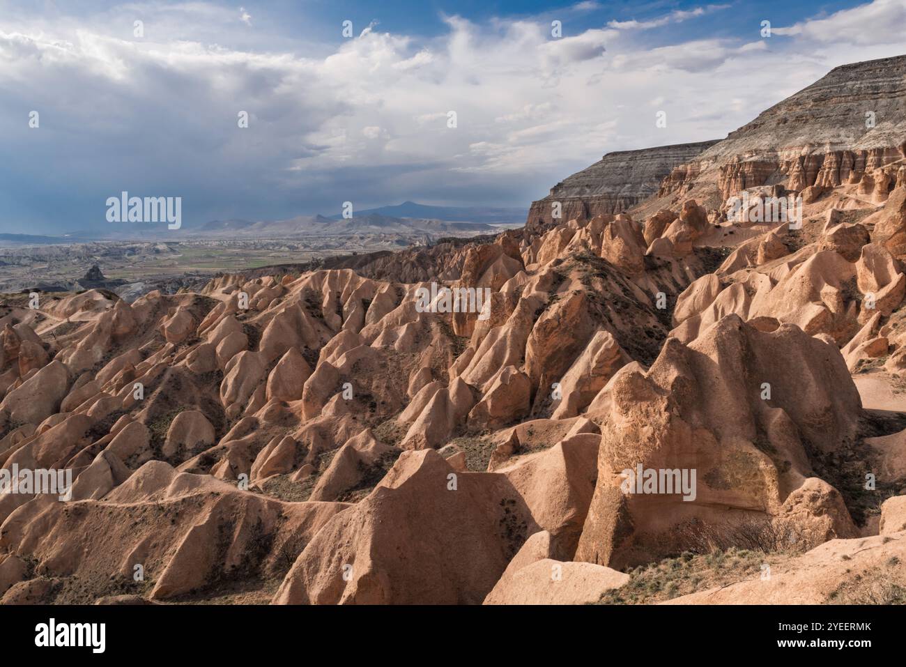 The rugged landscape of Cappadocia with dramatic rock formations under ...