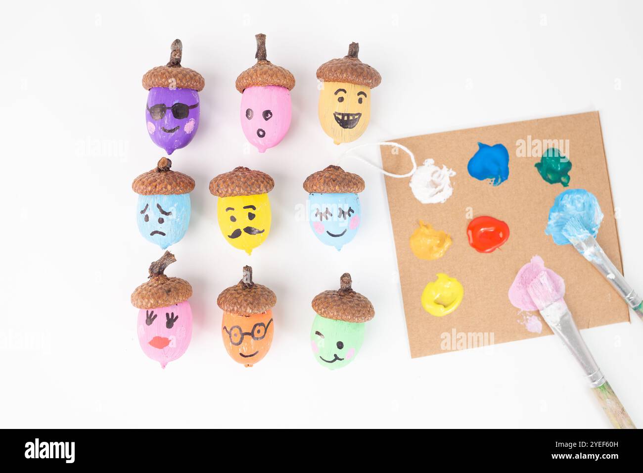 Painted acorns with faces, various colors, 3x3 grid, white background ...