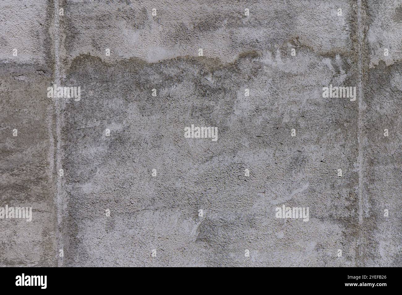 The surface of an aging concrete wall showcases a blend of textures and ...