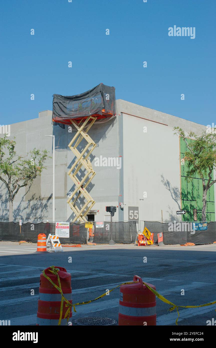 Multi story building under construction with a covered scissor scaffold ...
