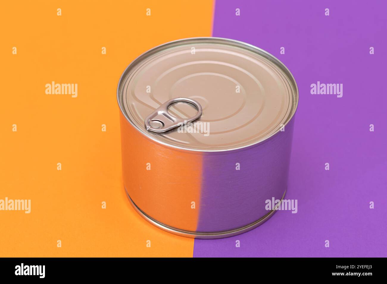 Unopened Tin Can on Split Orange and Violet Background. Canned Food ...