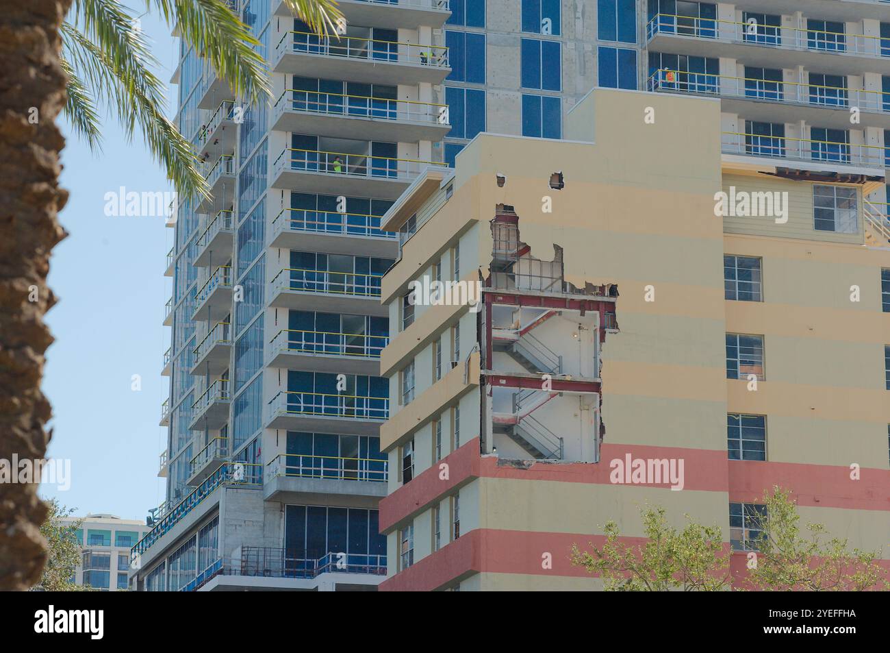 Powerful storms caused a large section of a multi story building wall ...