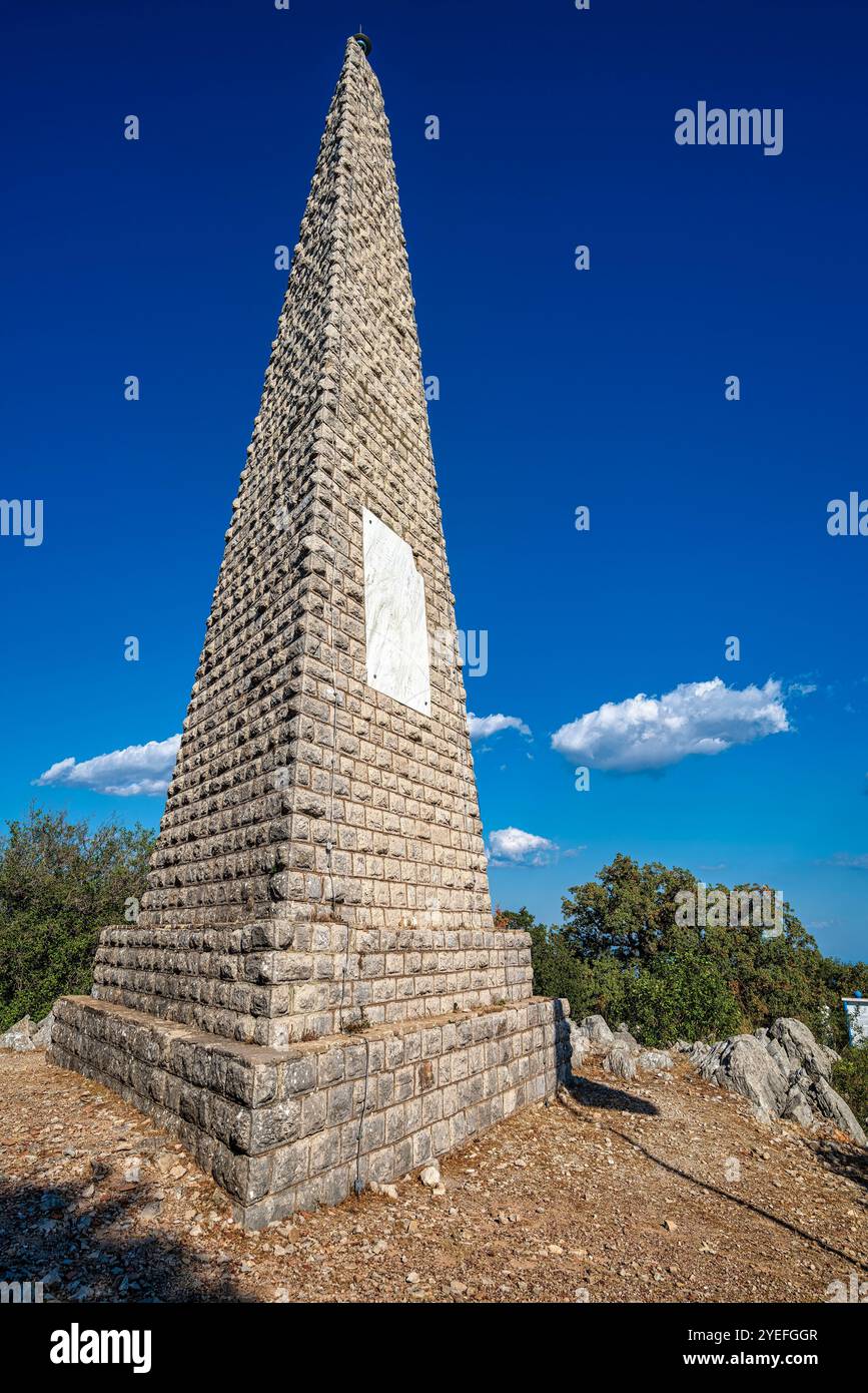 A tall, stone obelisk monument in Maniaki village, Greece ...