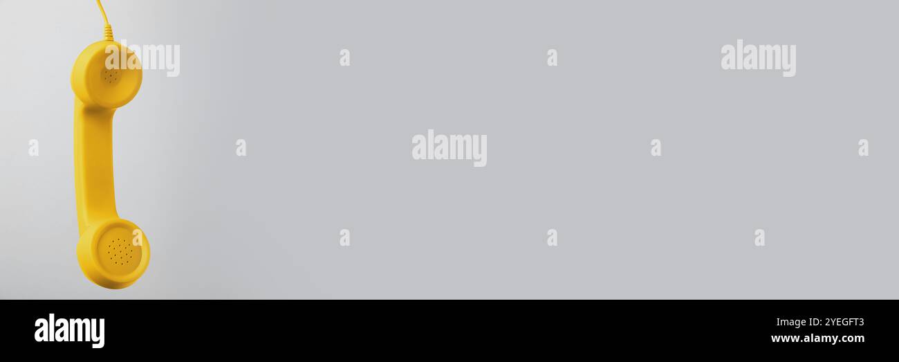 Yellow corded telephone handset on grey background. Banner design with ...