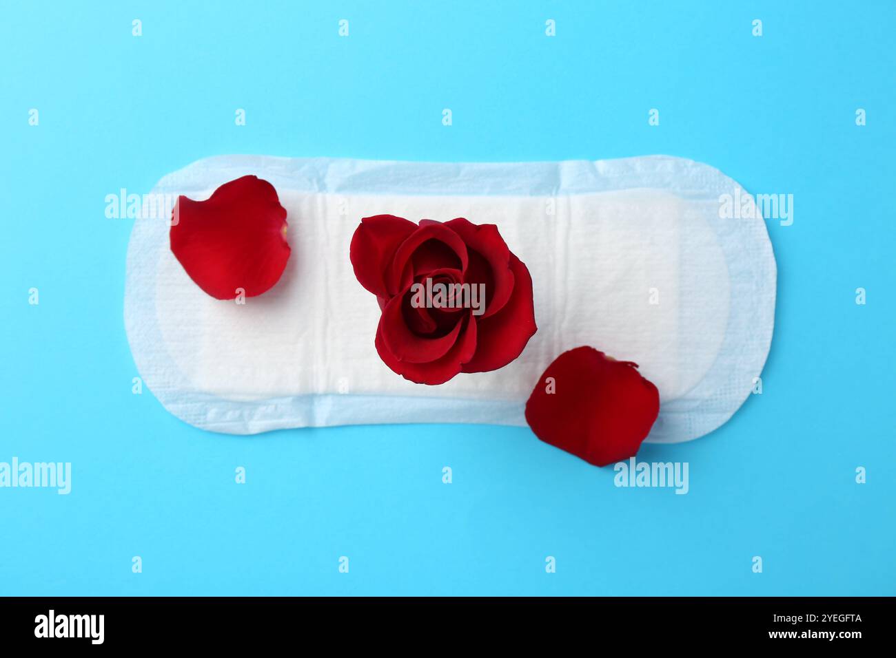 Menstrual pad with red flower on light blue background, top view Stock ...