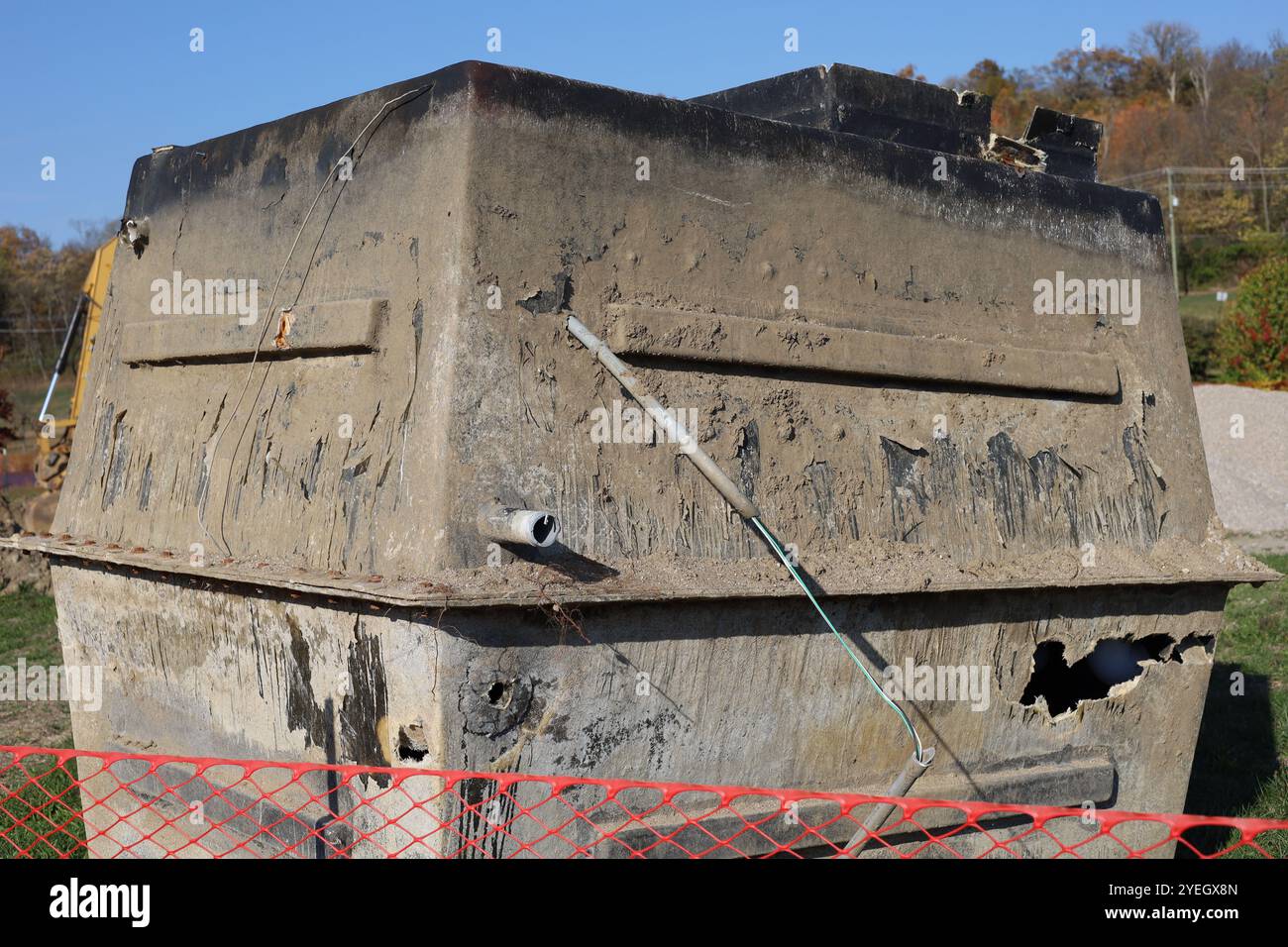 Dirty and worn rectangular container at construction site Stock Photo ...